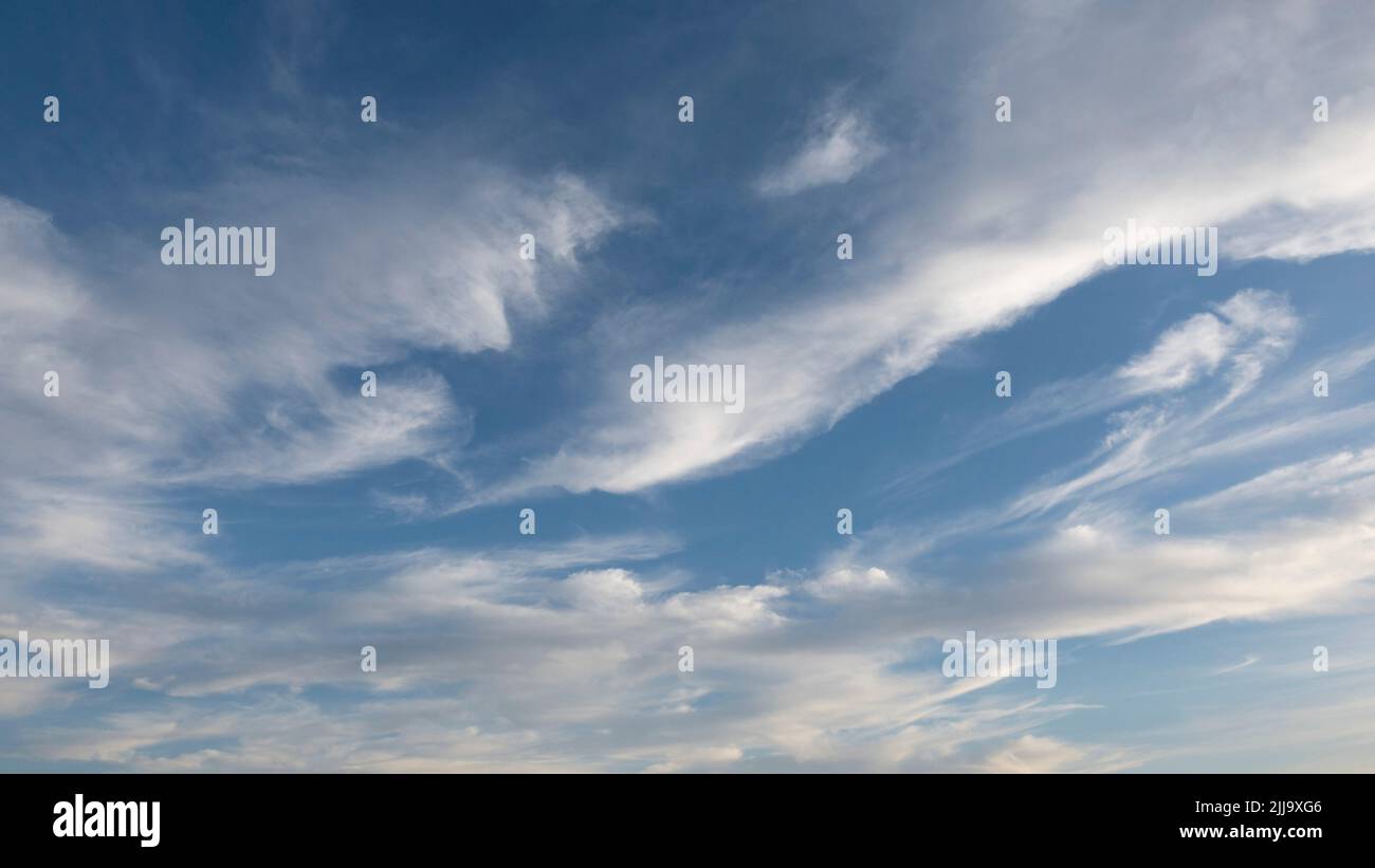 Beautiful wind shaped clouds and blue sky for background use or sky ...