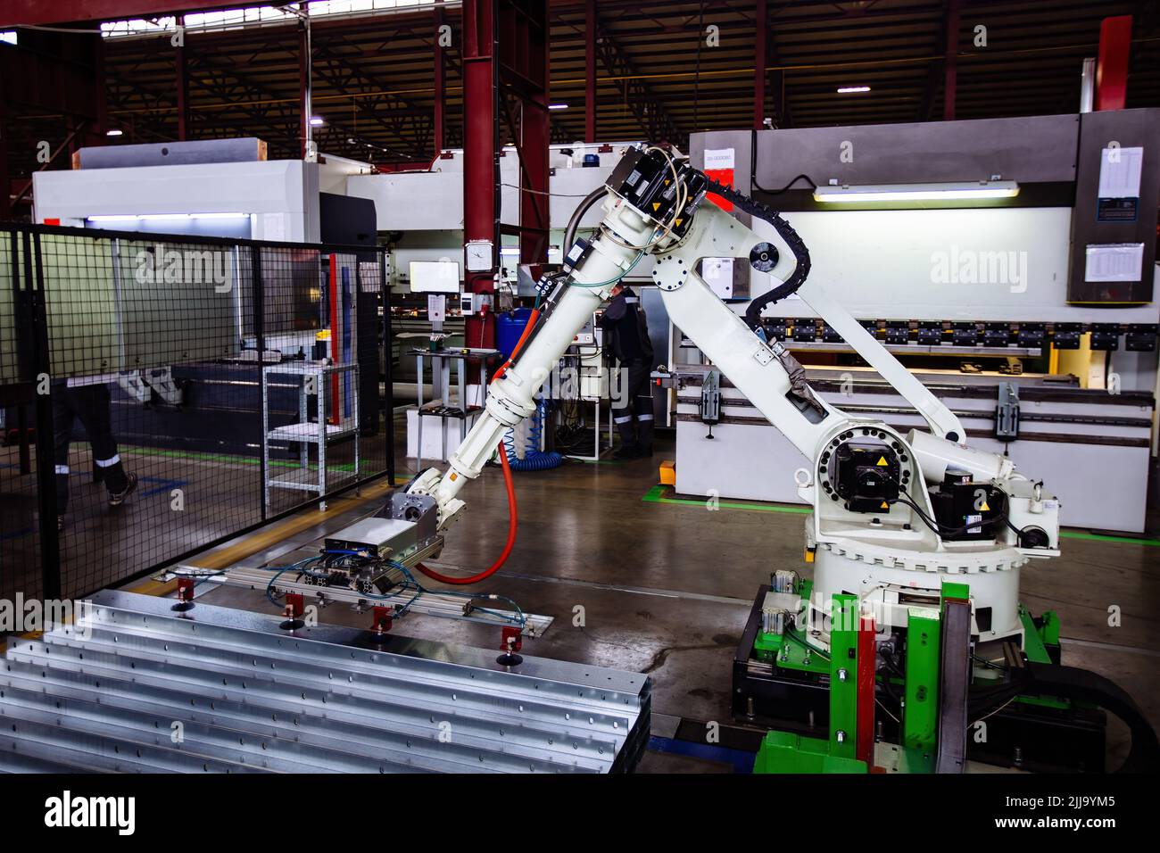 Robotic arm working with metal sheet at metalworking factory Stock ...