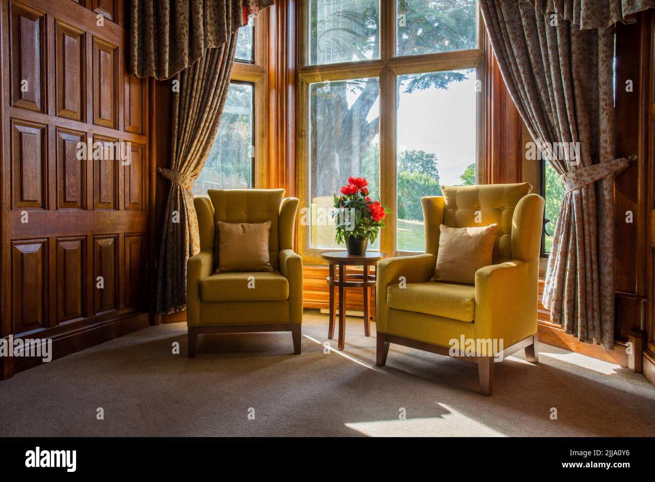 A beautiful shot of two elegant arms chairs in a stately home reception ...