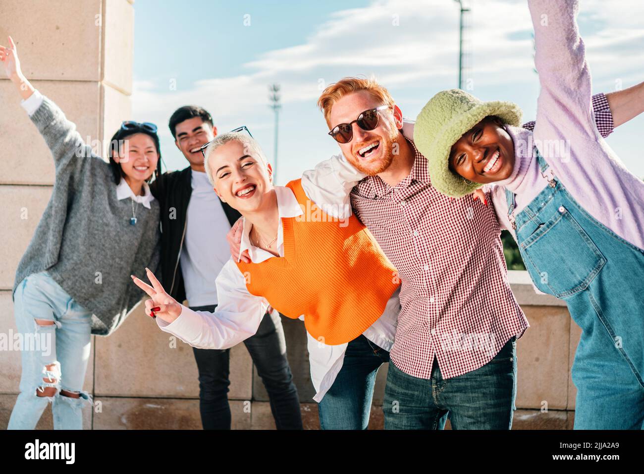 Five friends multi-ethnic posing in front of the camera smiling and ...
