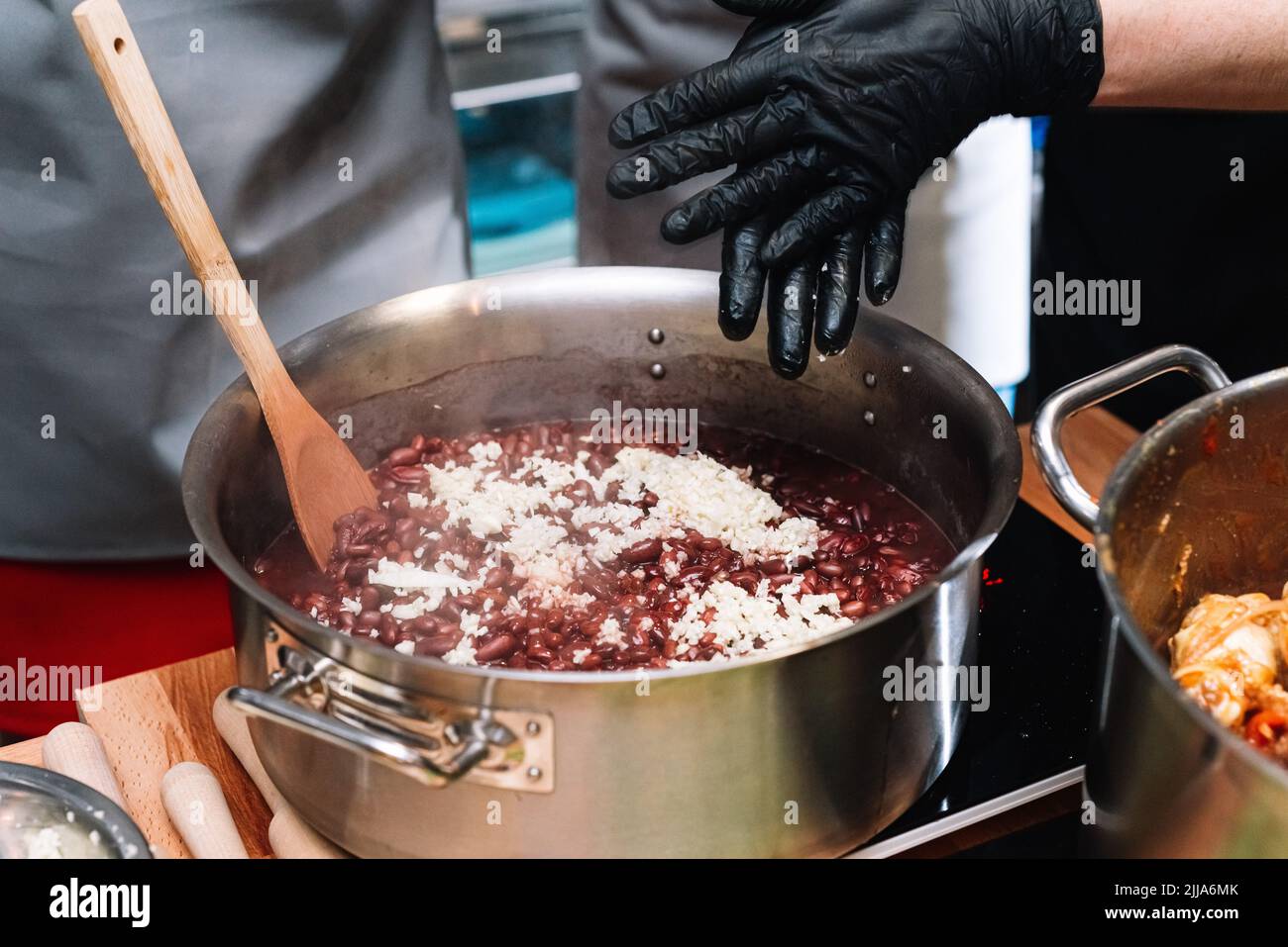 The red beans are cooked (boiling with garlic) in a saucepan on the ...