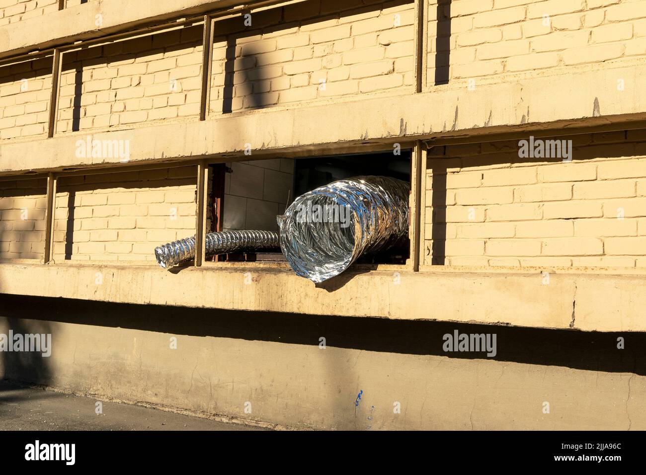 Flexible aluminum foil duct at the window. corrugated exhaust hose ...