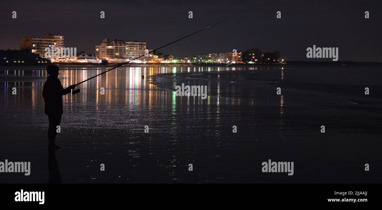 fishing on the beach in the night Stock Photo - Alamy