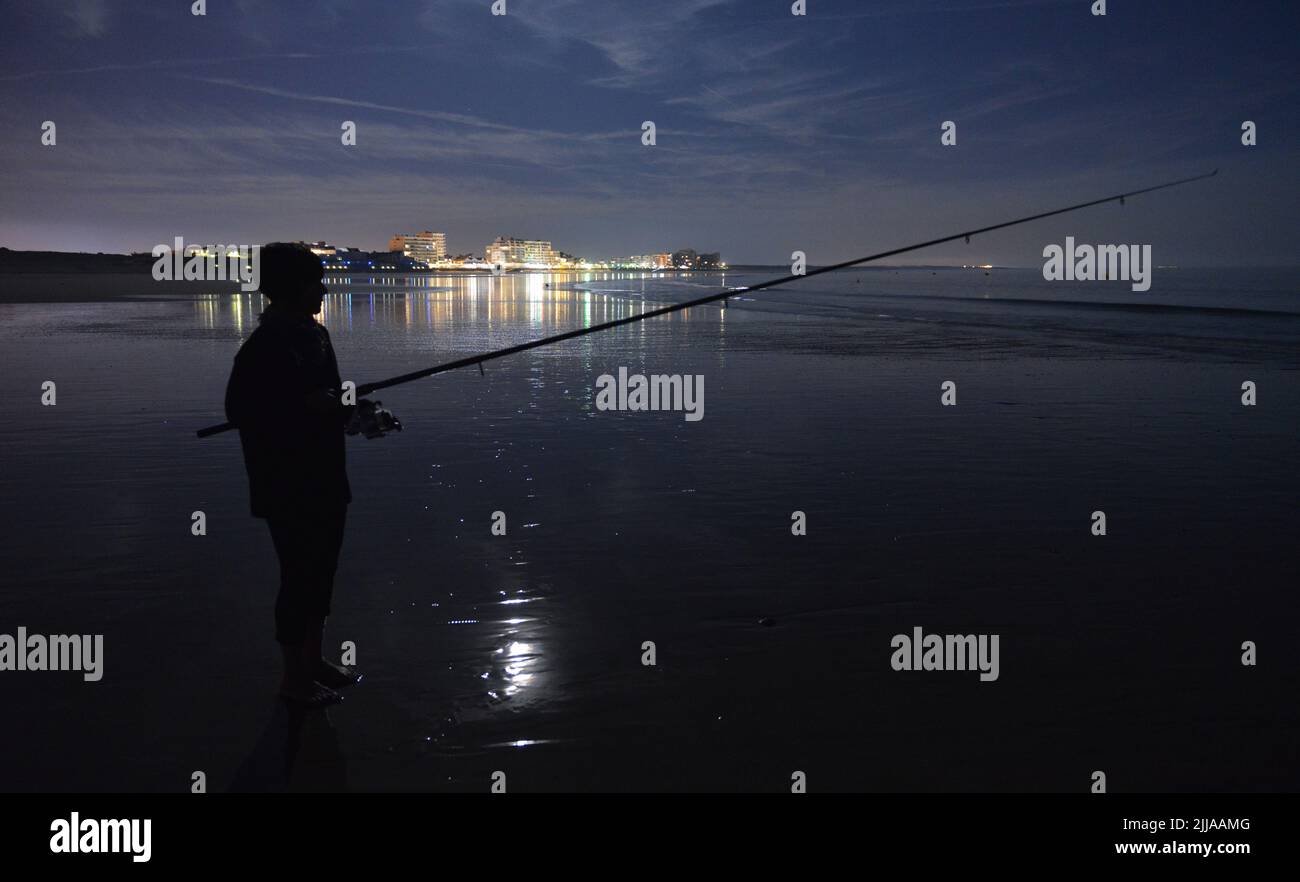 fishing on the beach in the night Stock Photo - Alamy