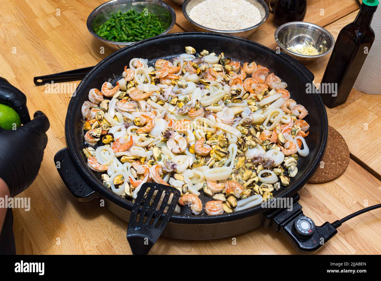 Seafood fried in a paella dish (paella pan). Seafood cocktail. Shrimp ...