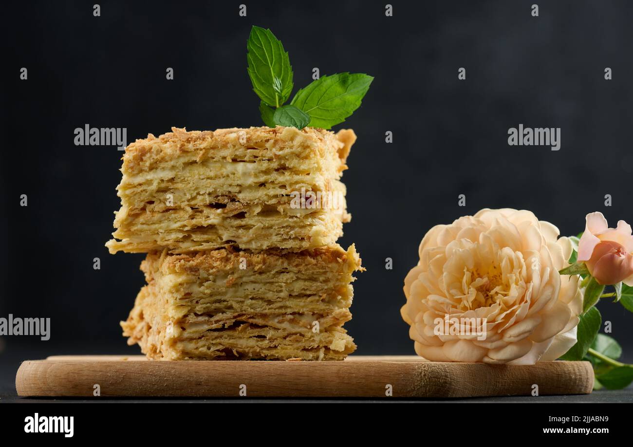 A stack of baked Napoleon pie slices with cream. Puff pastry, delicious ...