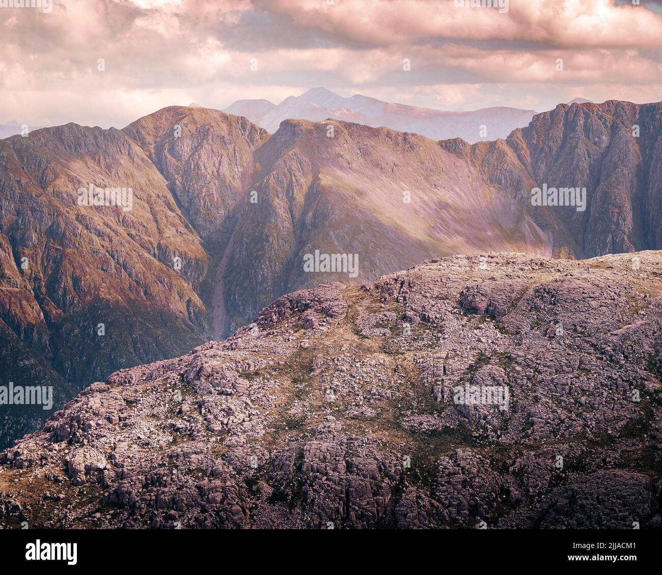 A beautiful view of mountains with a pink cloudy sky background Stock ...
