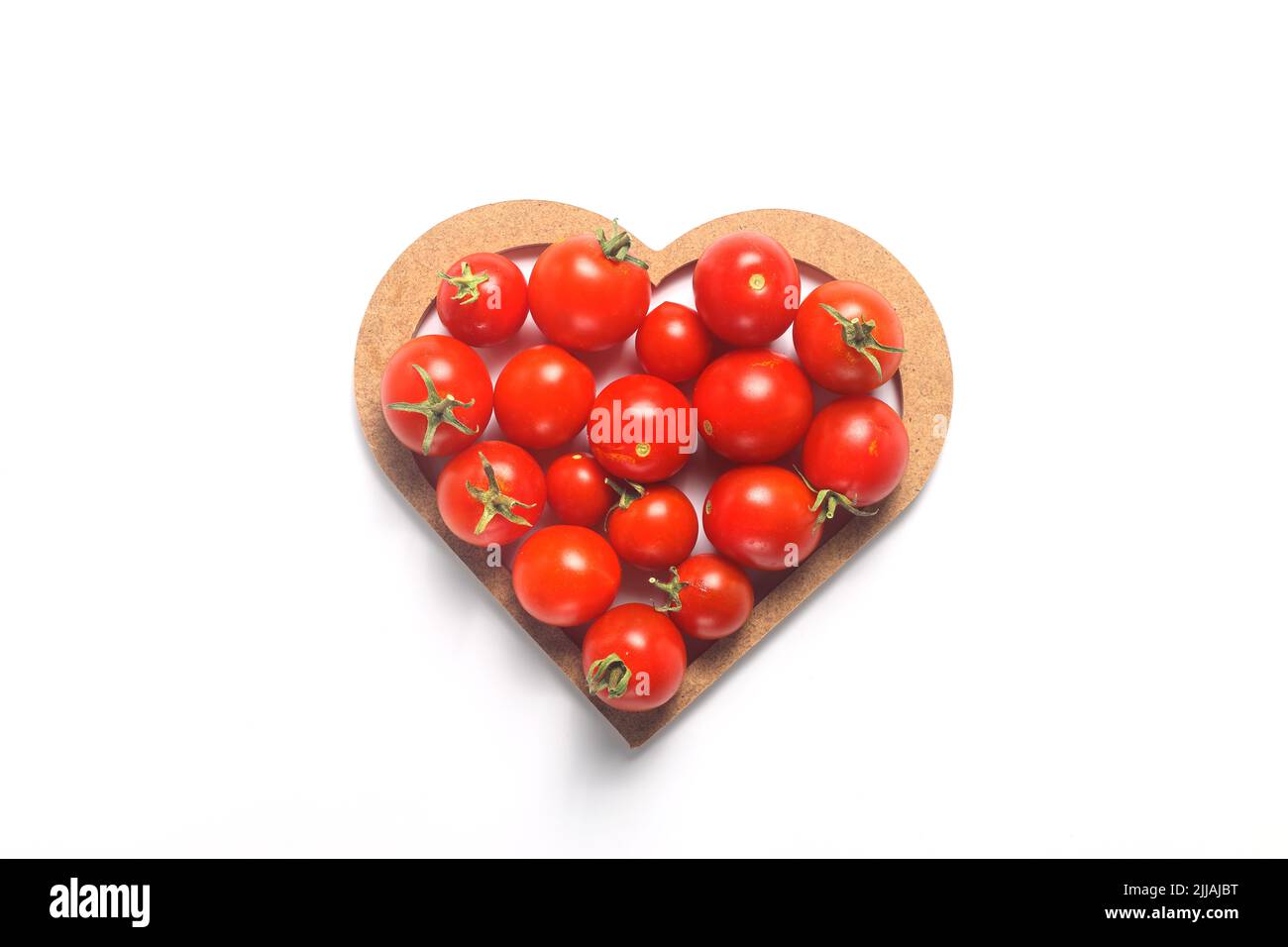 heart shaped tomatoes on a white background Stock Photo - Alamy