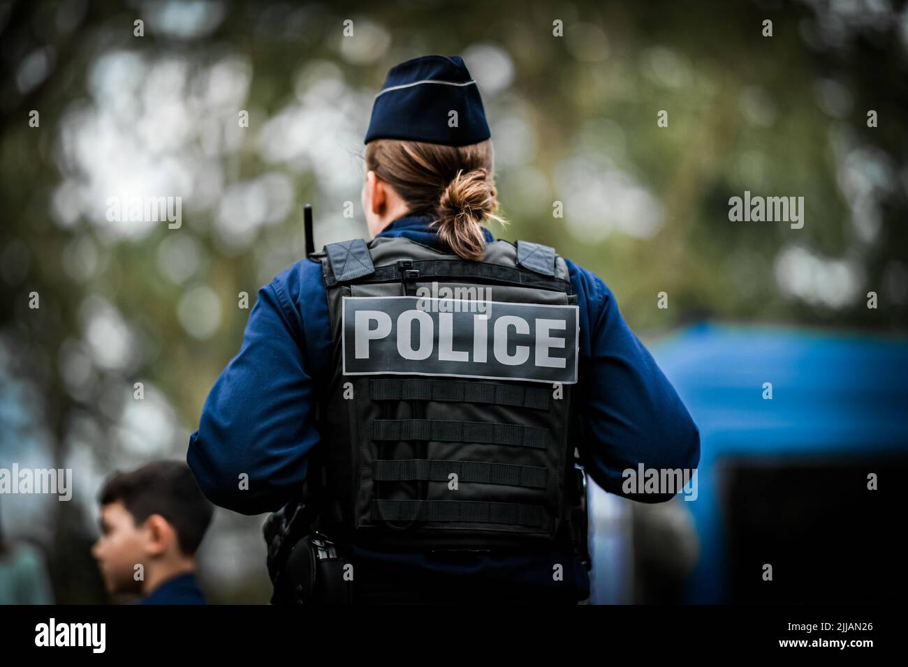 A female police officer (woman) with uniform ensuring security in Paris ...