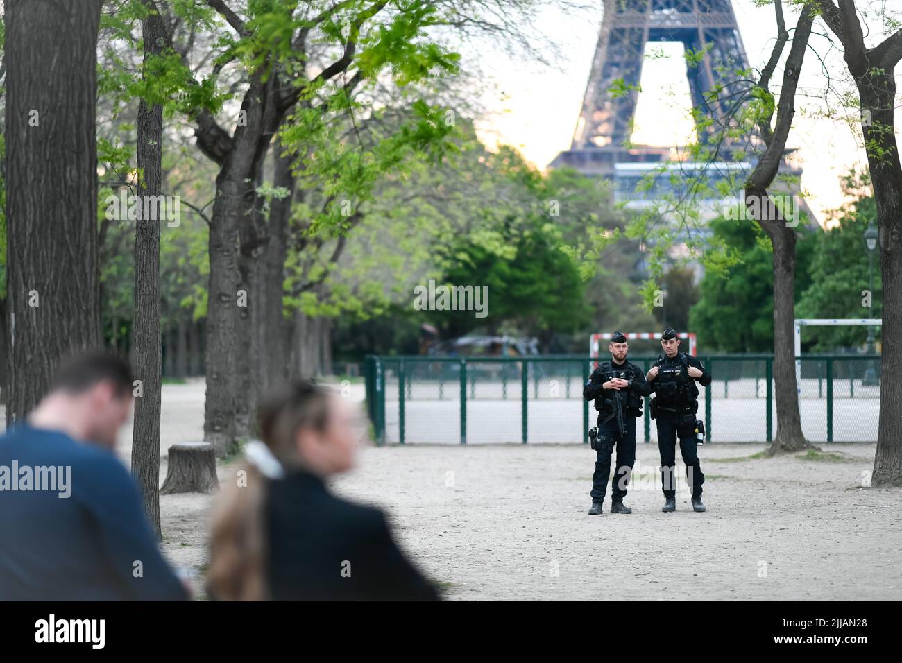 Police officers walk the streets with uniform near Eiffel Tower (Tour ...