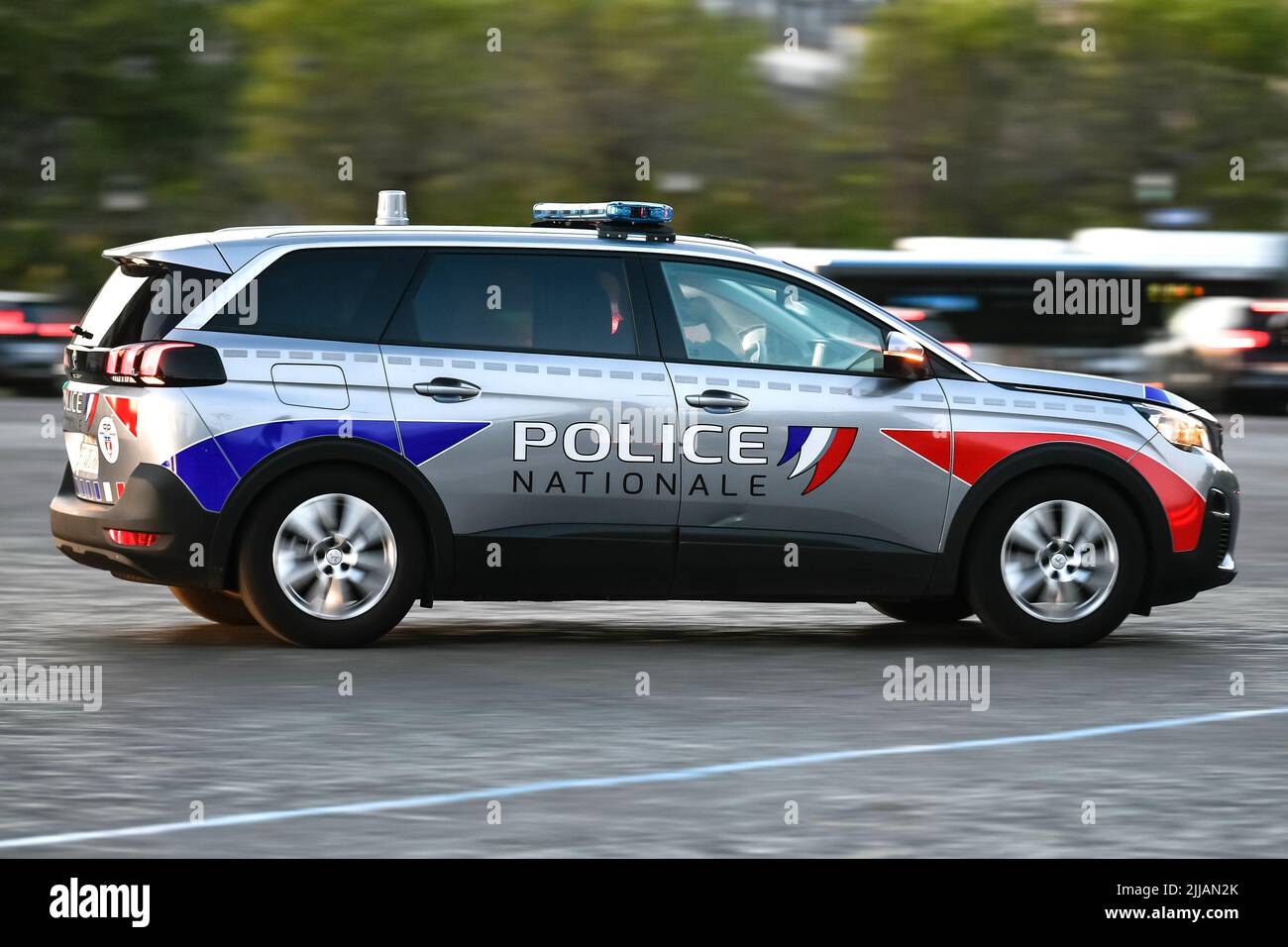 A police car (the new Peugeot 5008) drives through the city ensuring ...