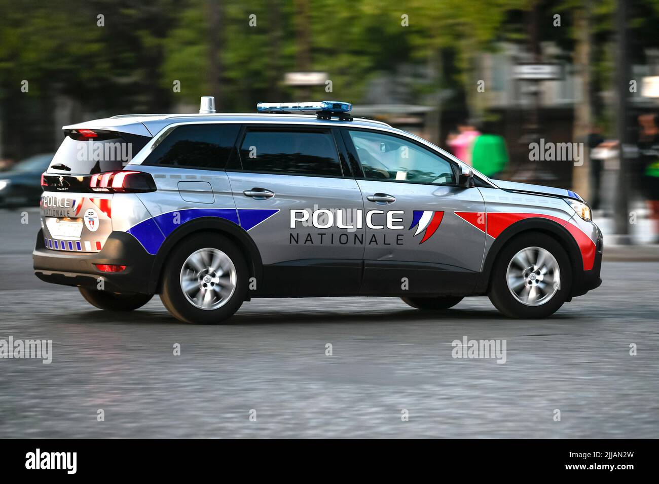 A police car (the new Peugeot 5008) drives through the city ensuring ...
