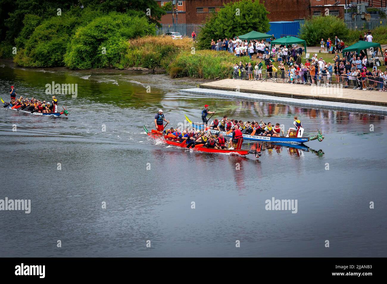 Three Dragon Boats racing along the River Mersey in the final ...