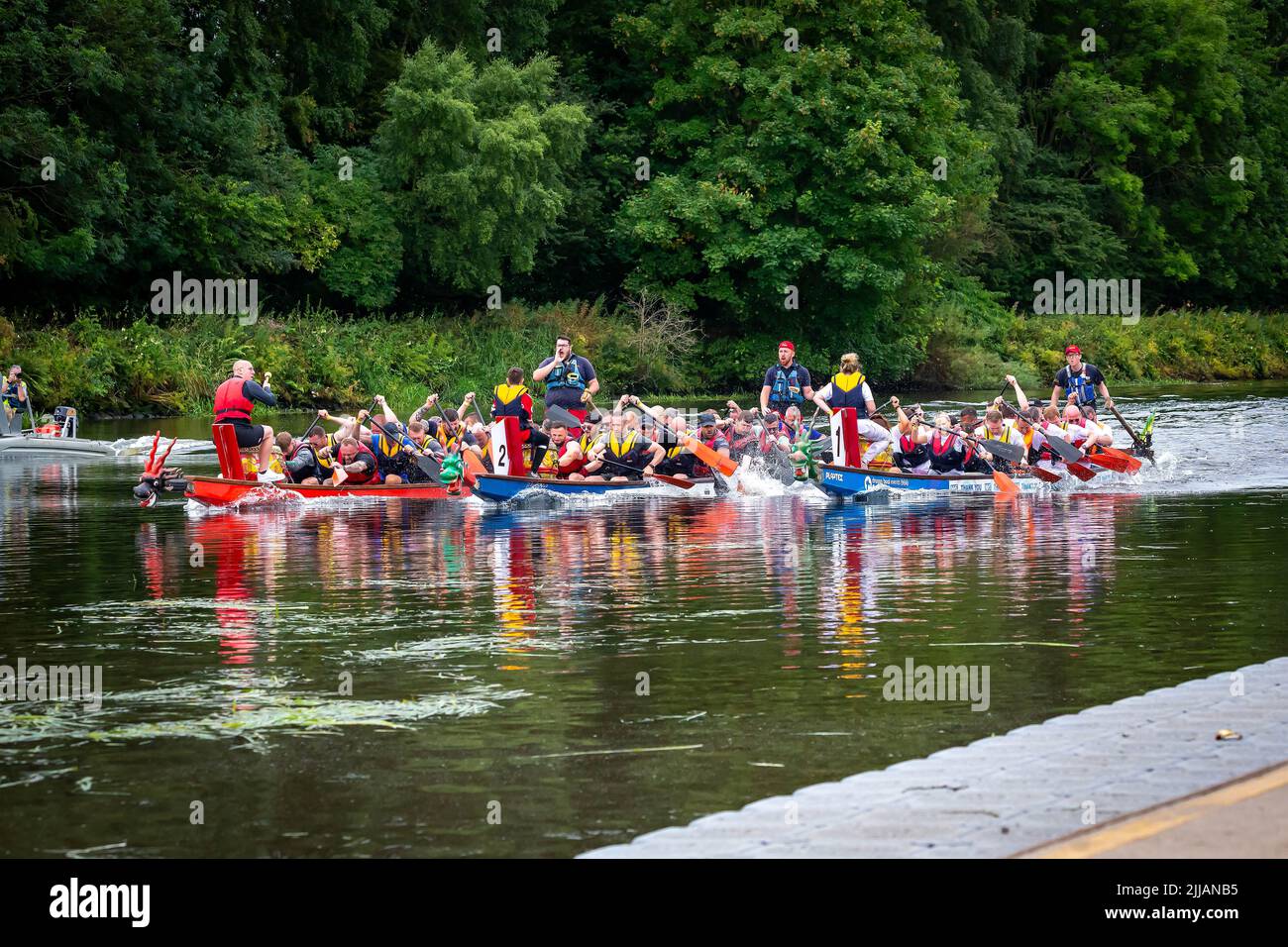 Three Dragon Boats racing along the River Mersey in the final ...