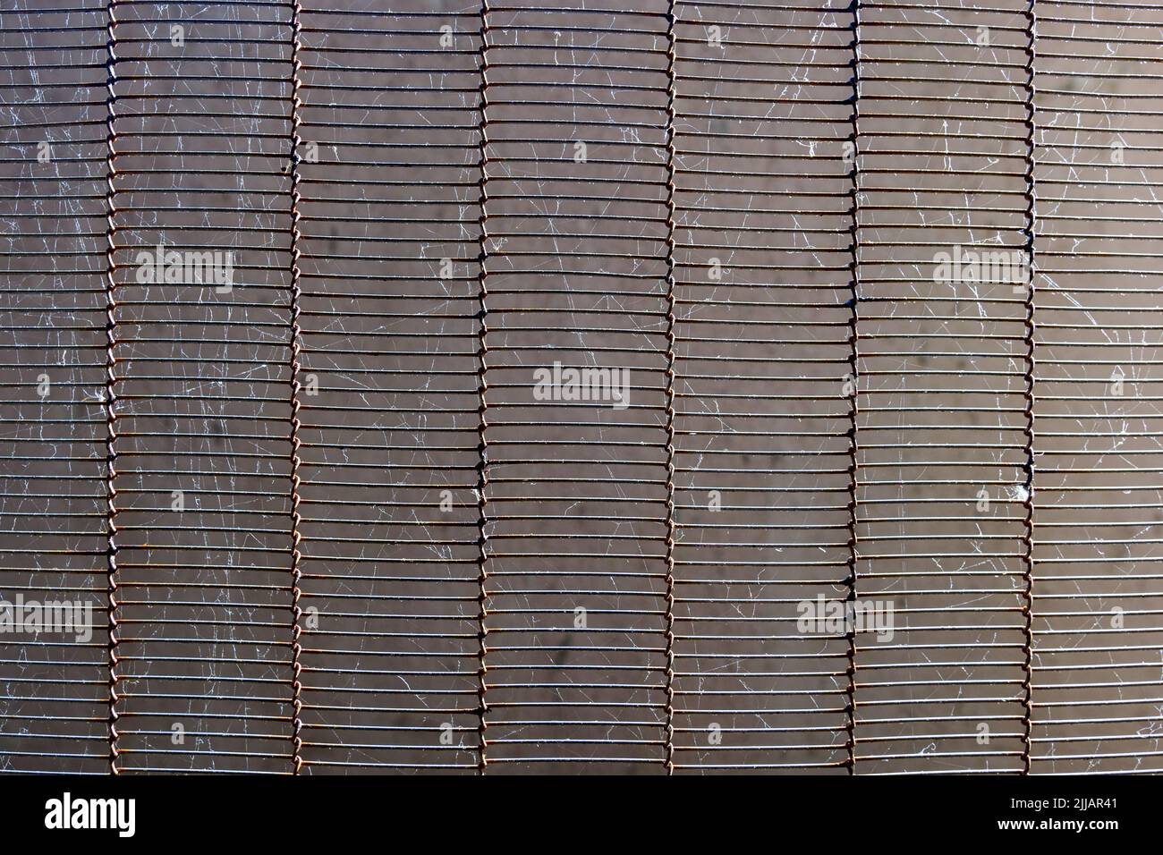 Selective focus and close up view of dirty rectangular metal wire mesh ...