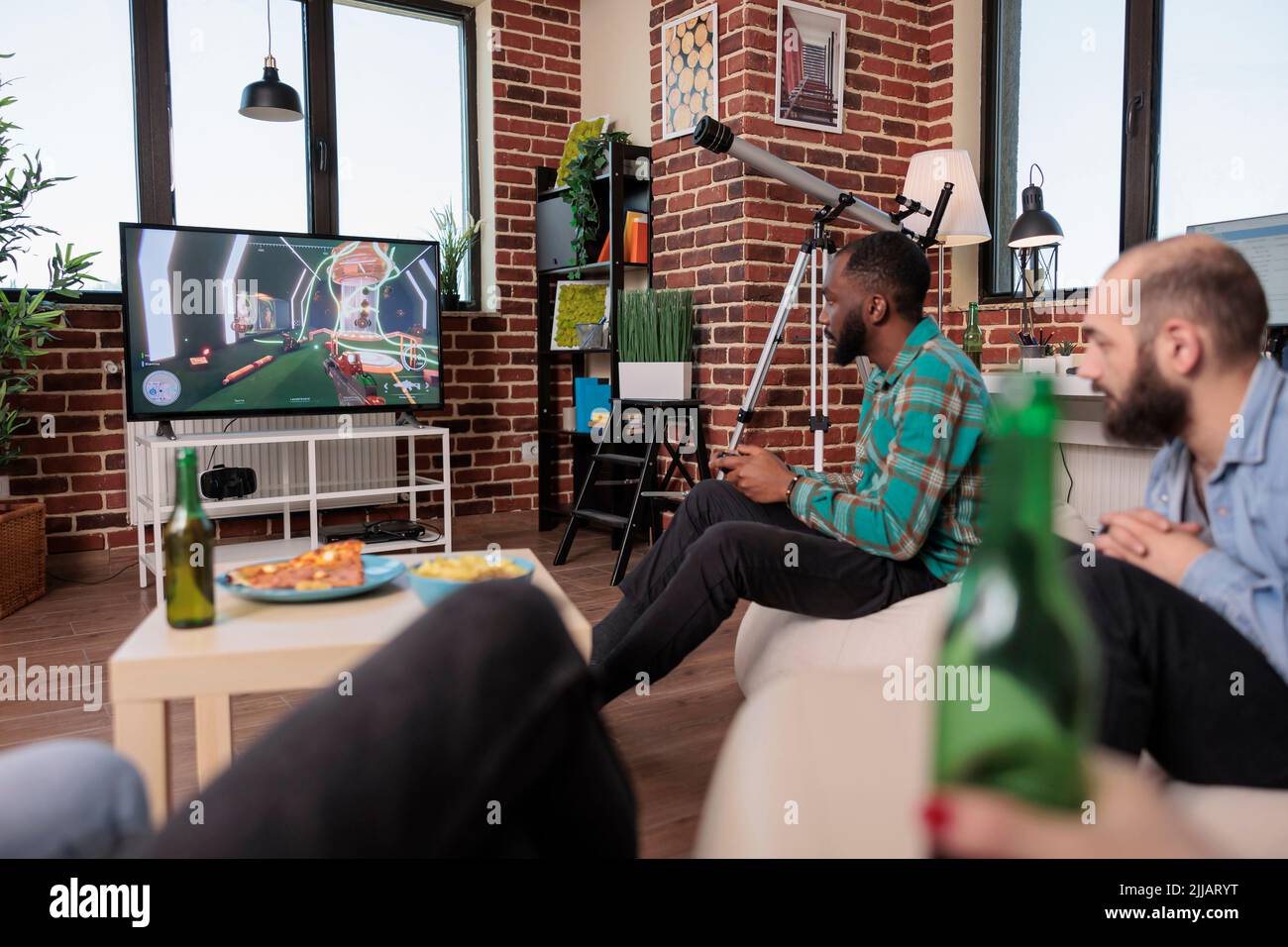 Diverse group of people playing shooting video games on tv console ...