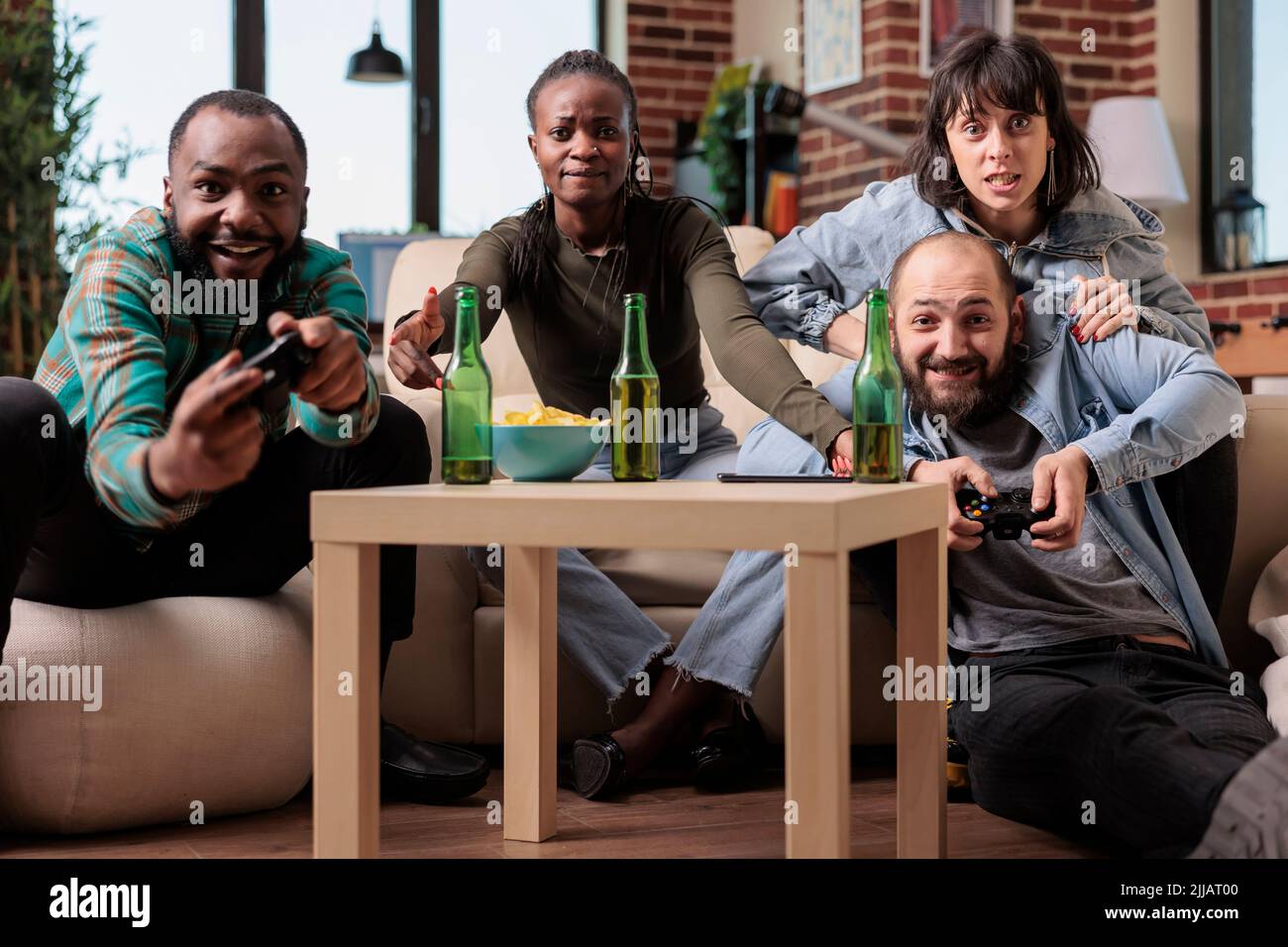 Diverse group of people playing video games together on console, having ...