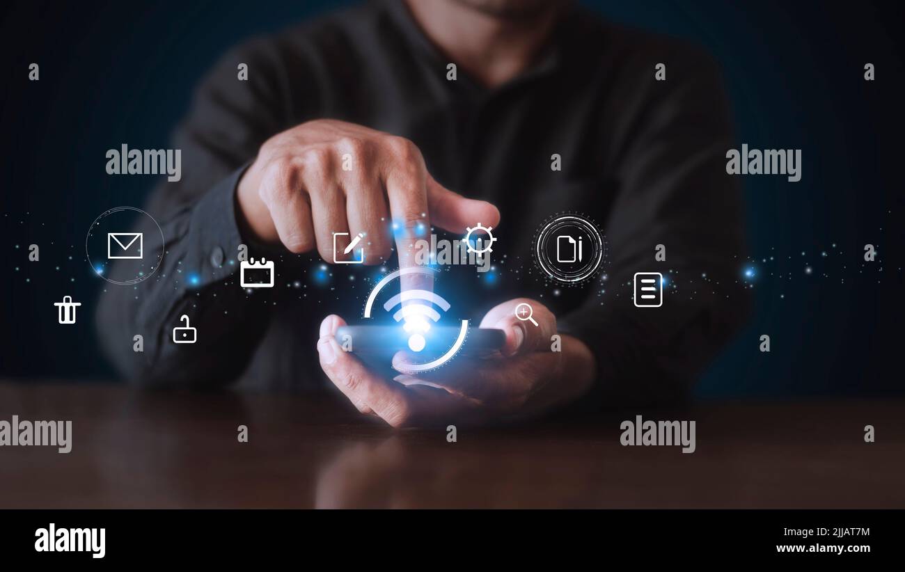 Businessman using phone and touching on virtual screen contact icons ...