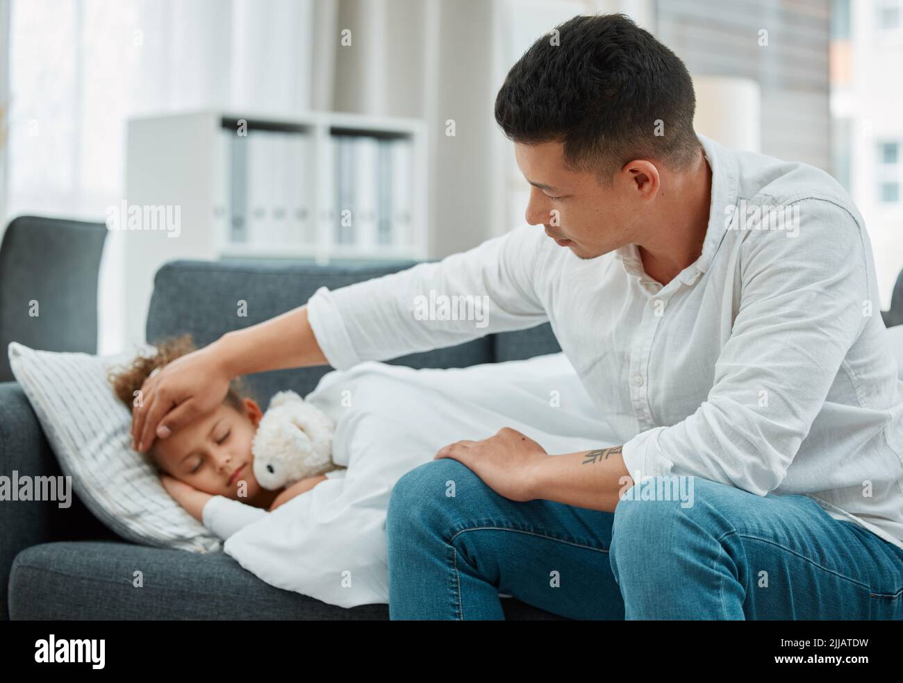 A parents worst nightmare. a father checking his daughter for a fever ...