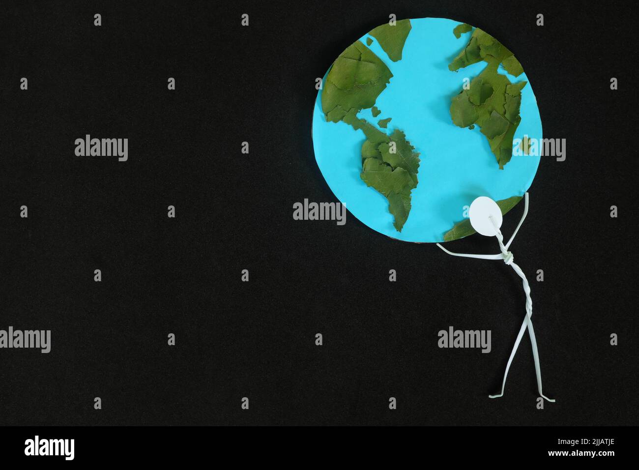 Human stick figure man carrying the earth on his shoulders on dark ...
