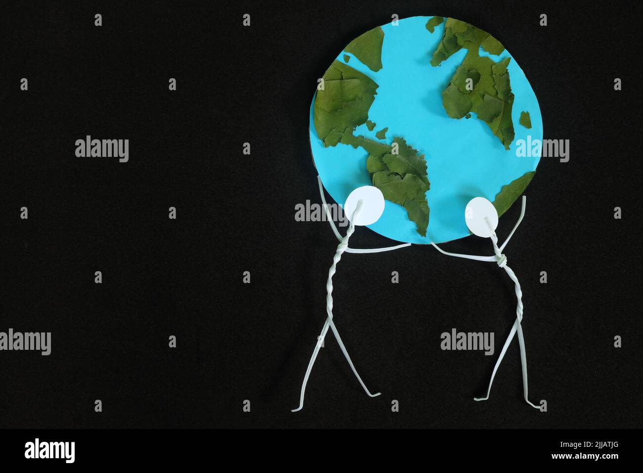Two human stick figure man carrying the earth on shoulders on dark ...
