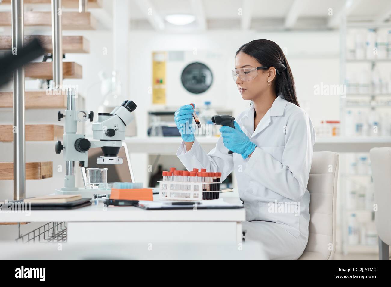 Sorting through samples for further analysis. a young scientist using a ...