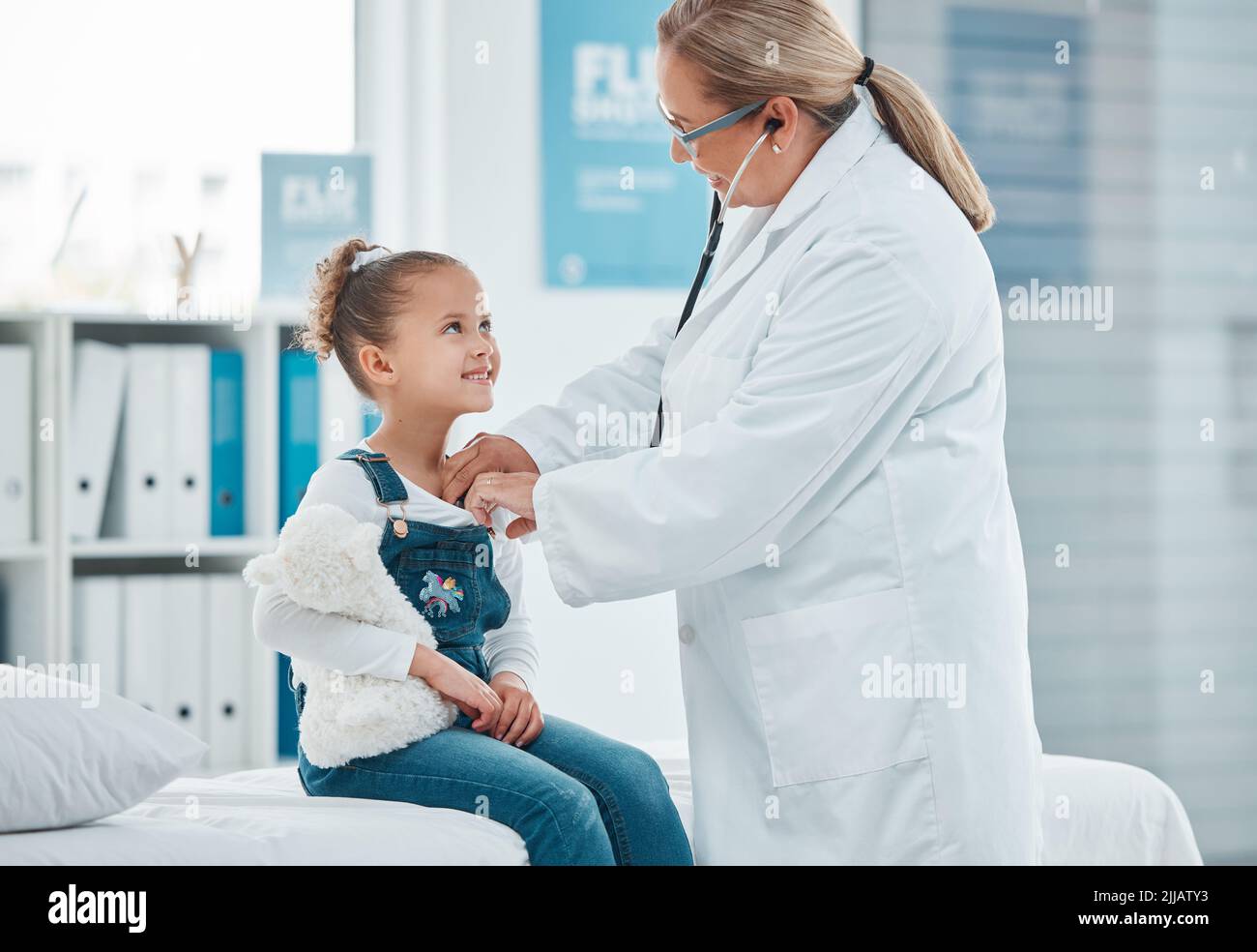 Making sure shes healthy and growing well. a doctor examining a little ...