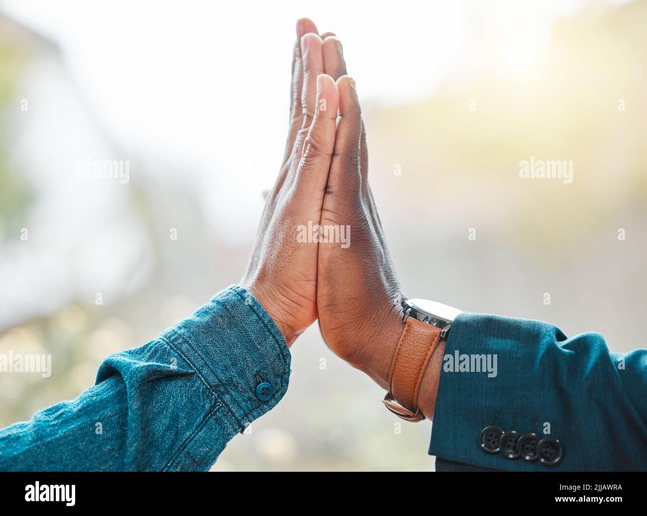 Two businessmen high fiving hi-res stock photography and images - Alamy