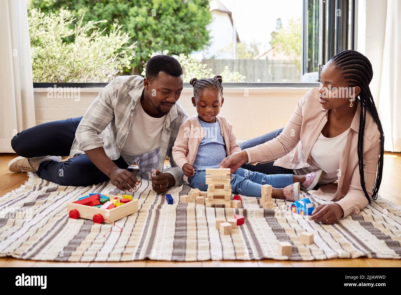 How high can you build it. a little girl playing with blocks with her ...
