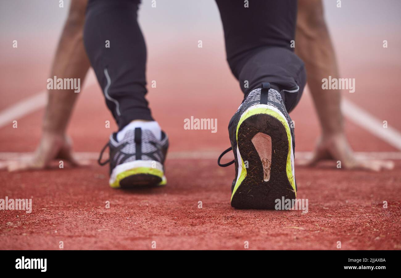 Ready for launch. Rearview shot of an unrecognizable young male athlete ...