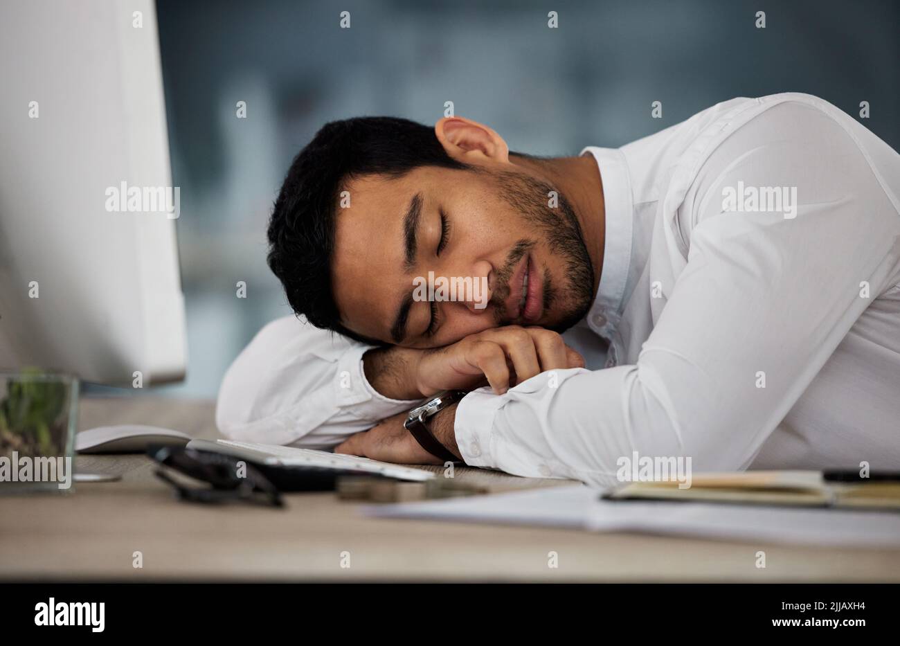 Processing the information of the day. a young businessman taking a nap ...