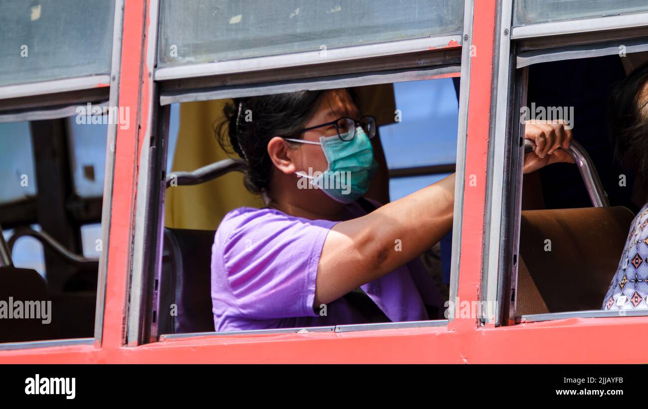 Bangkok Thailand July 2022 people with mas in a red bus public ...