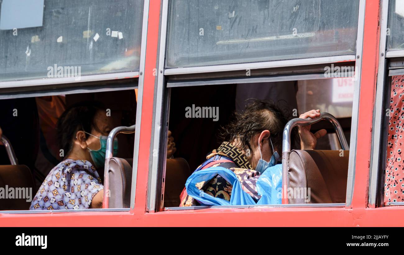 Bangkok Thailand July 2022 people with mas in a red bus public ...