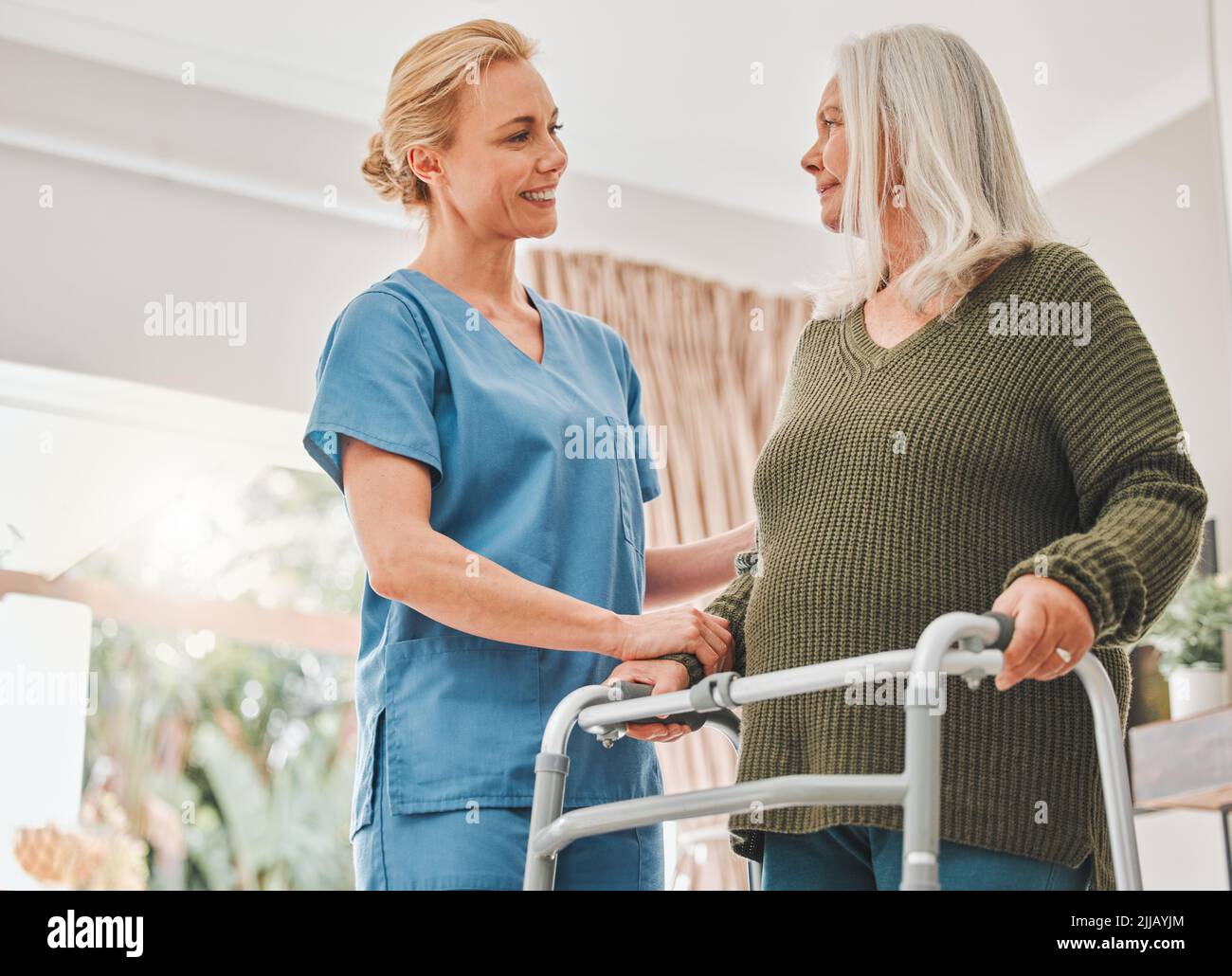 Old woman walking frame hi-res stock photography and images - Alamy