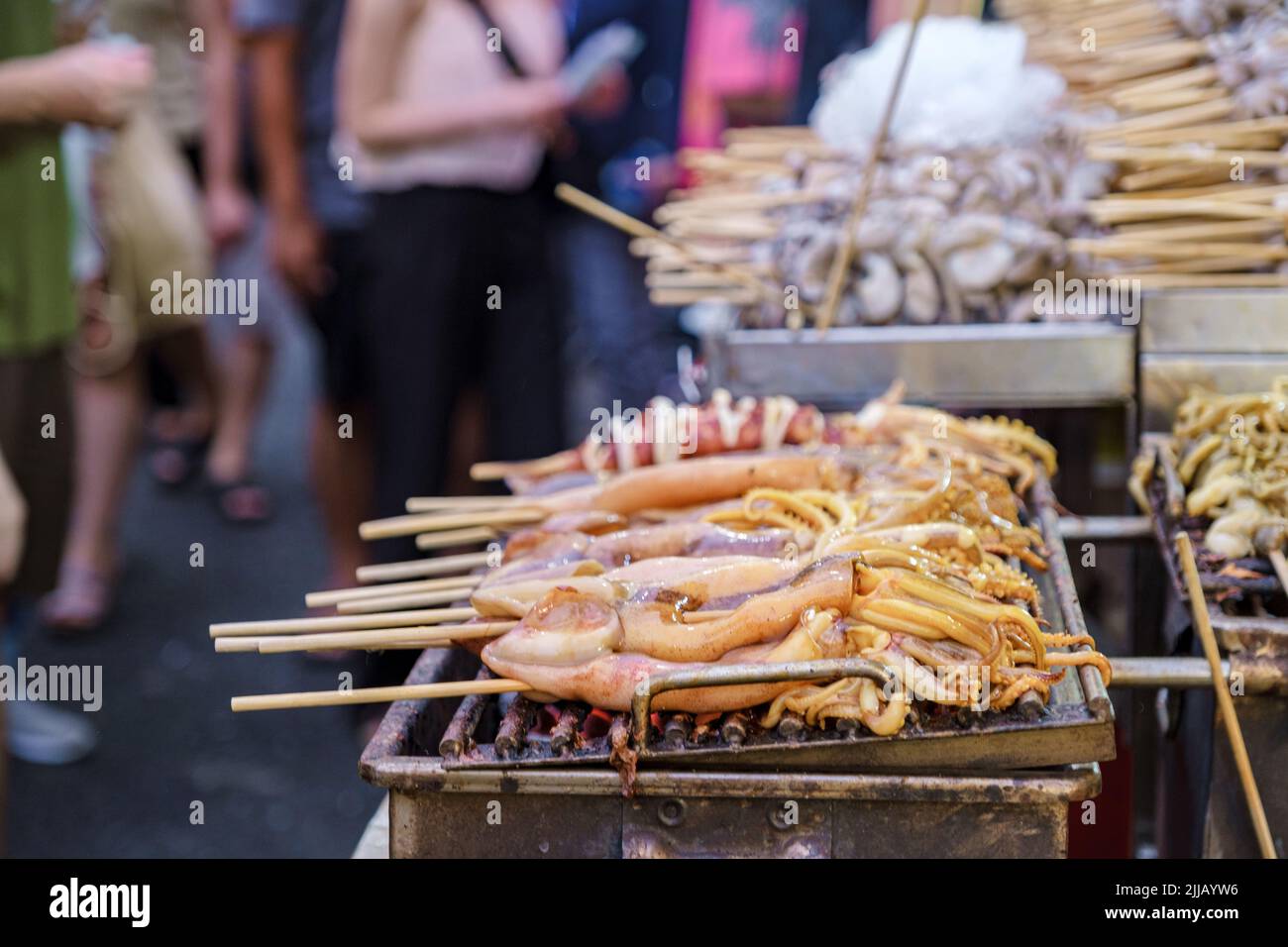 Grilled squid on a cast iron grill over a charcoal grill, Calamari fish ...