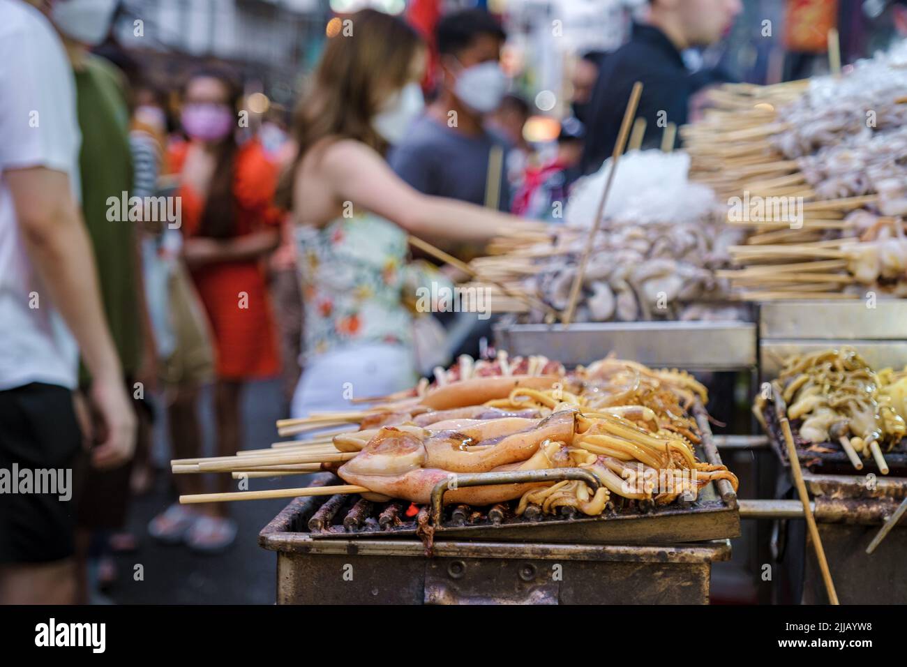 Grilled squid on a cast iron grill over a charcoal grill, Calamari fish ...