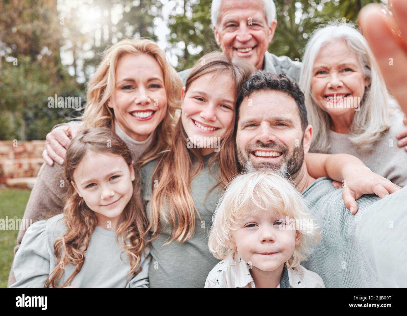 This is all of us. a multi-generational family posing together outside ...