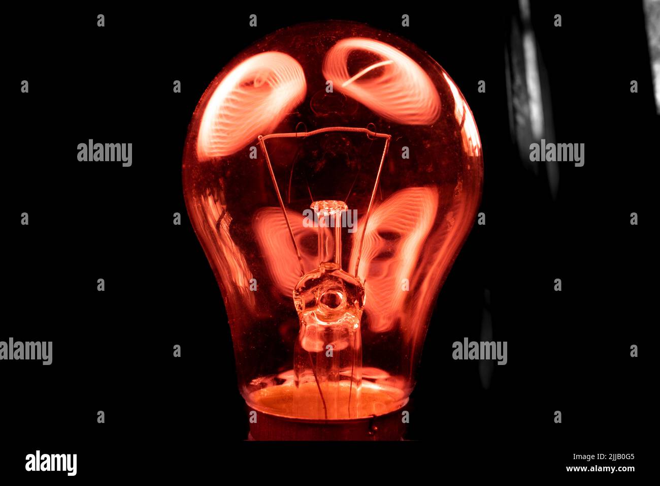Light bulb close-up in the dark in red highlights Stock Photo - Alamy
