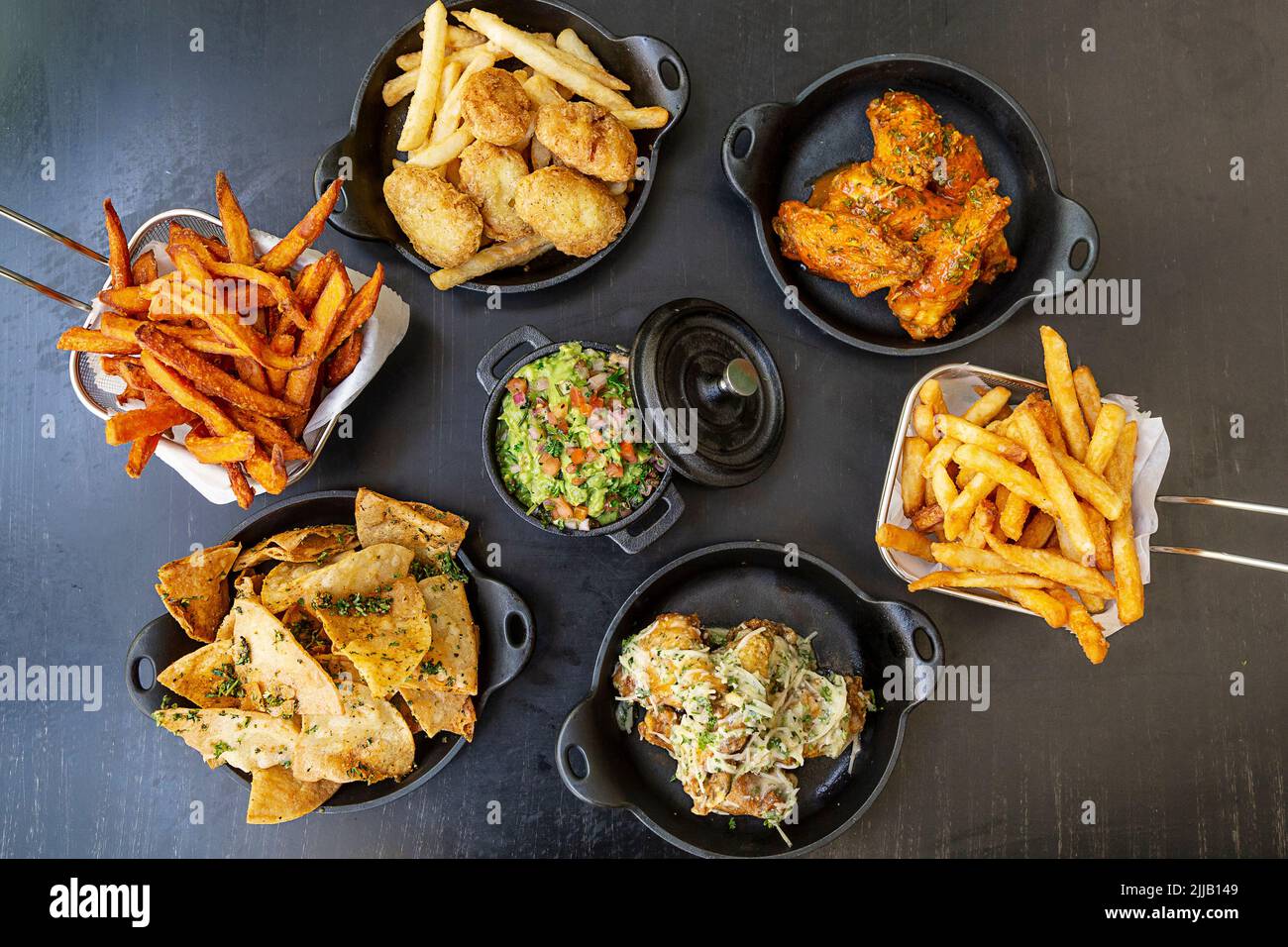 French fries, sweet potato fries, guacamole, chicken wings and tortilla ...