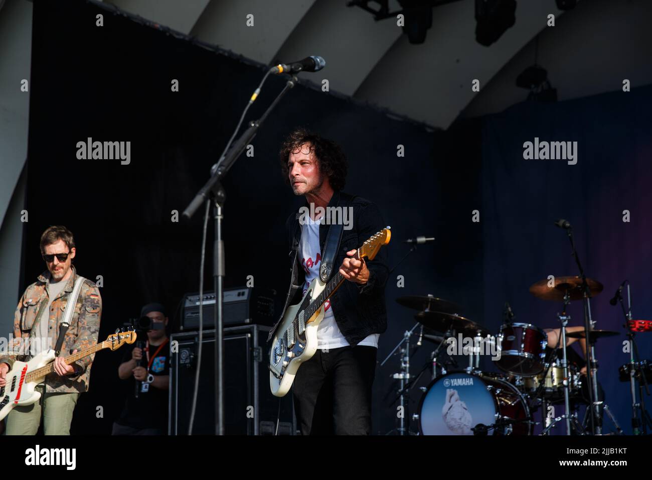 Sam Roberts (centre) plays guitar and sings on stage with bassist James ...