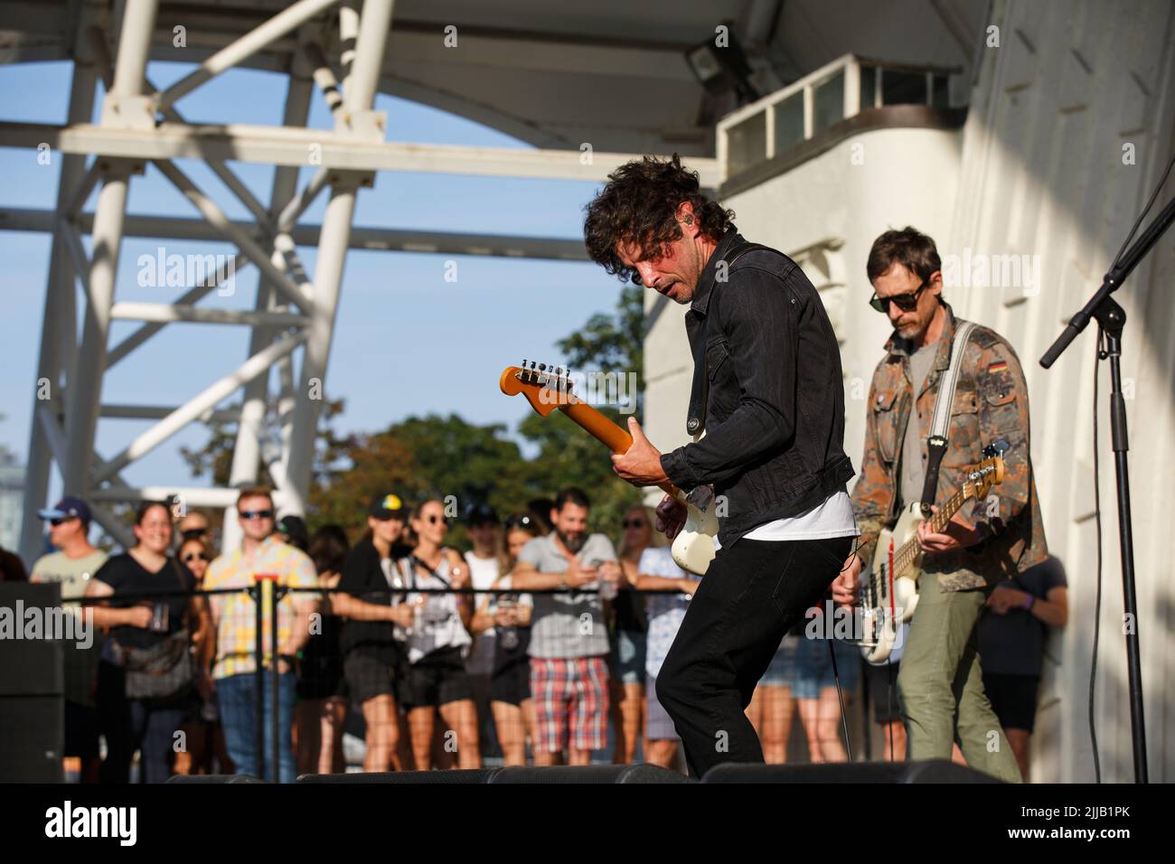 Sam Roberts plays guitar and sings on stage with bassist James Hall and ...