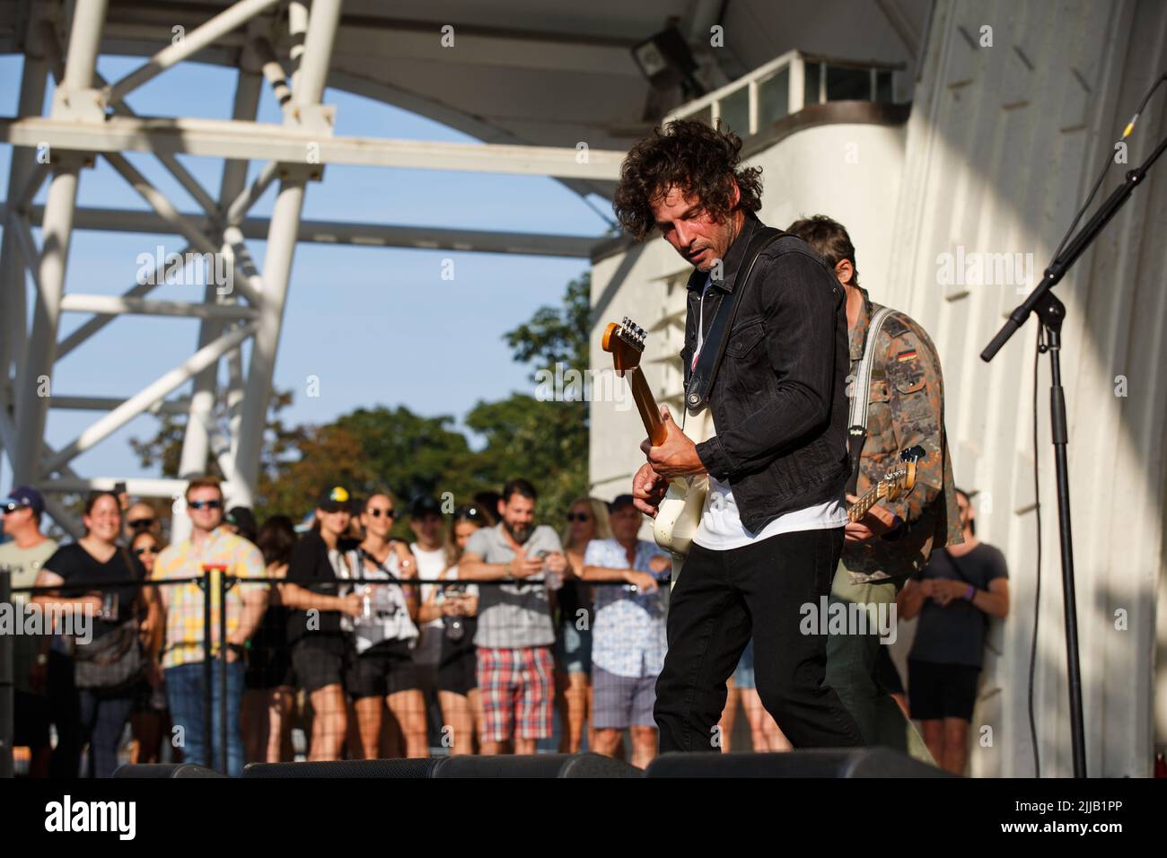 Sam Roberts plays guitar and sings on stage with bassist James Hall and ...