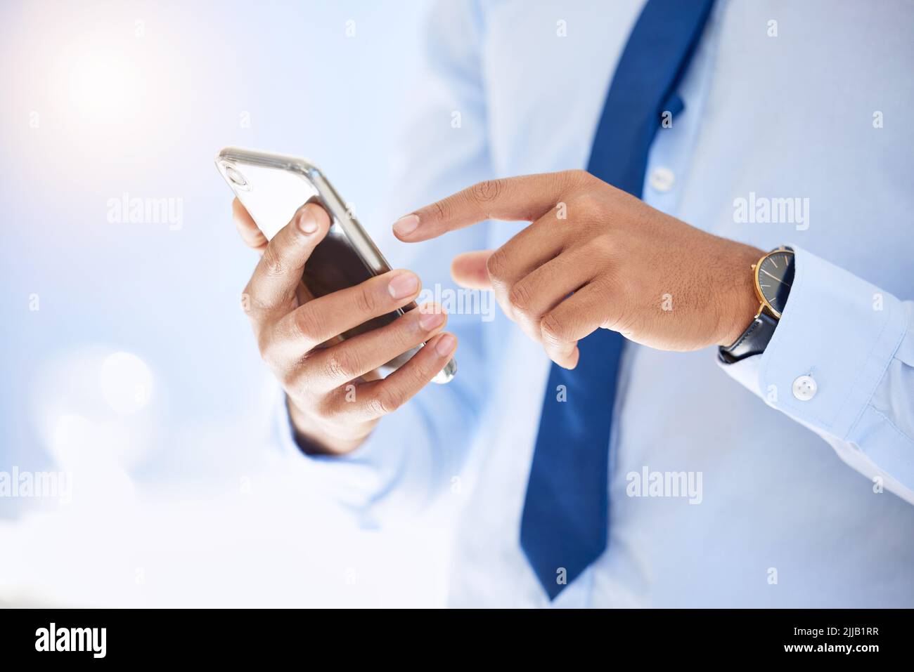 Working no matter where I am. a businessman using his smartphone to ...