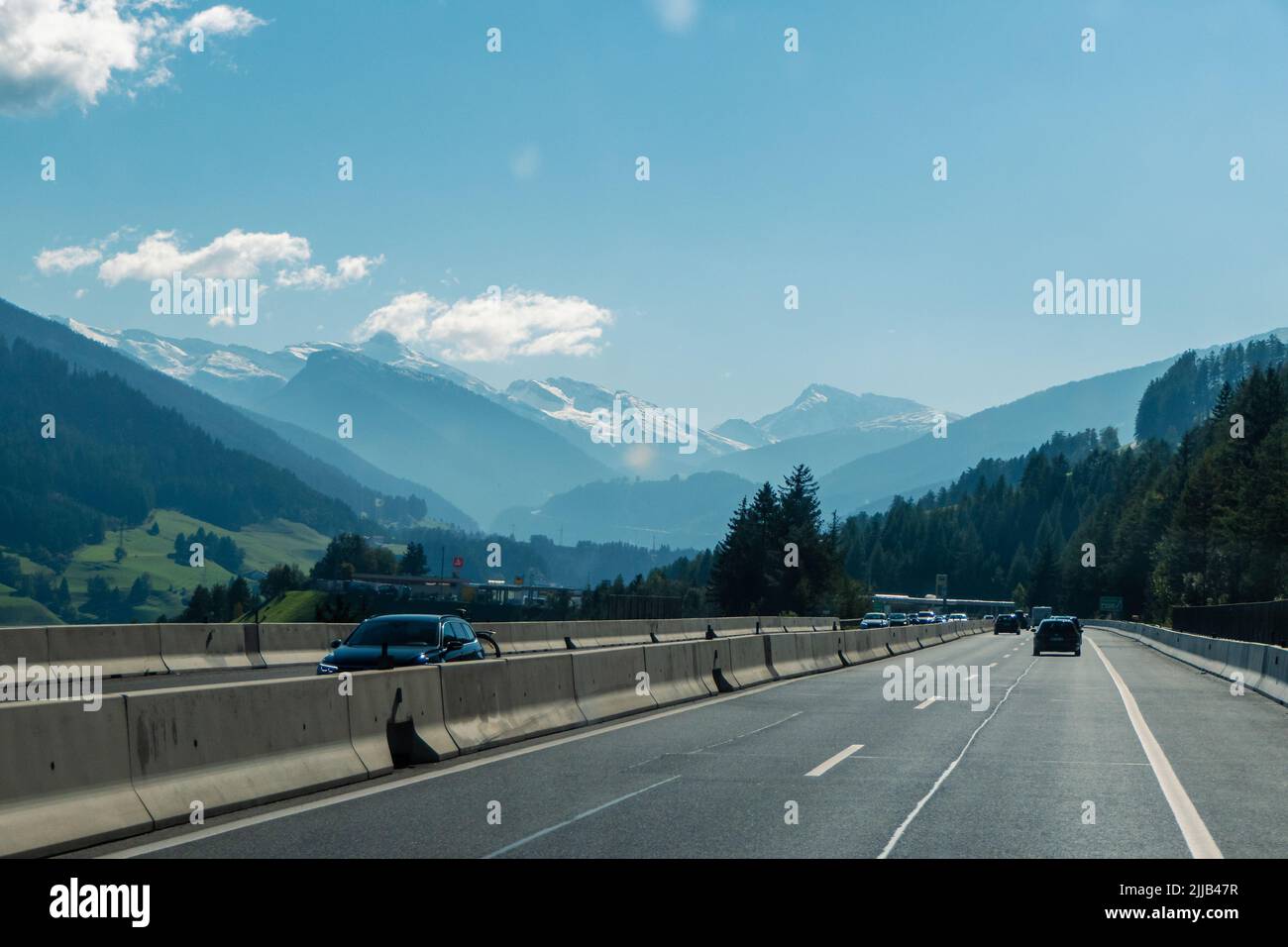A busy road and the mountainous landscape of Germany under a clear sky ...