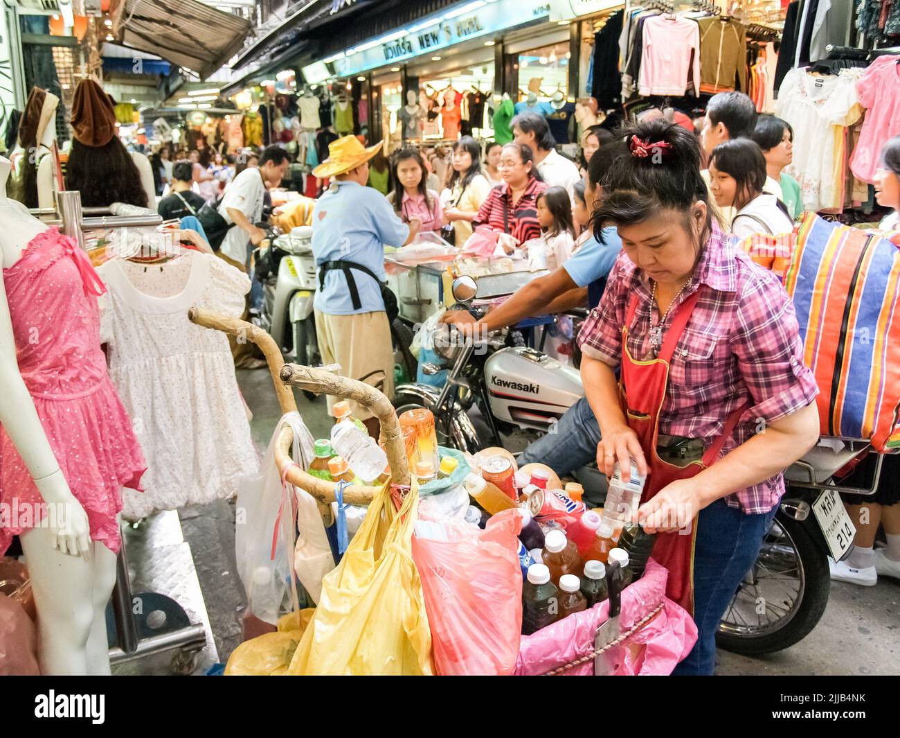 Woman tend product on her market stall in busy Bangkok street Stock ...
