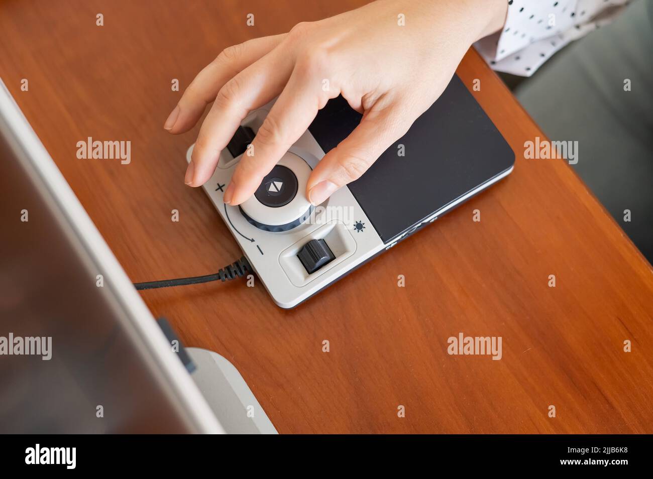 A woman uses a special magnification device for the visually impaired ...