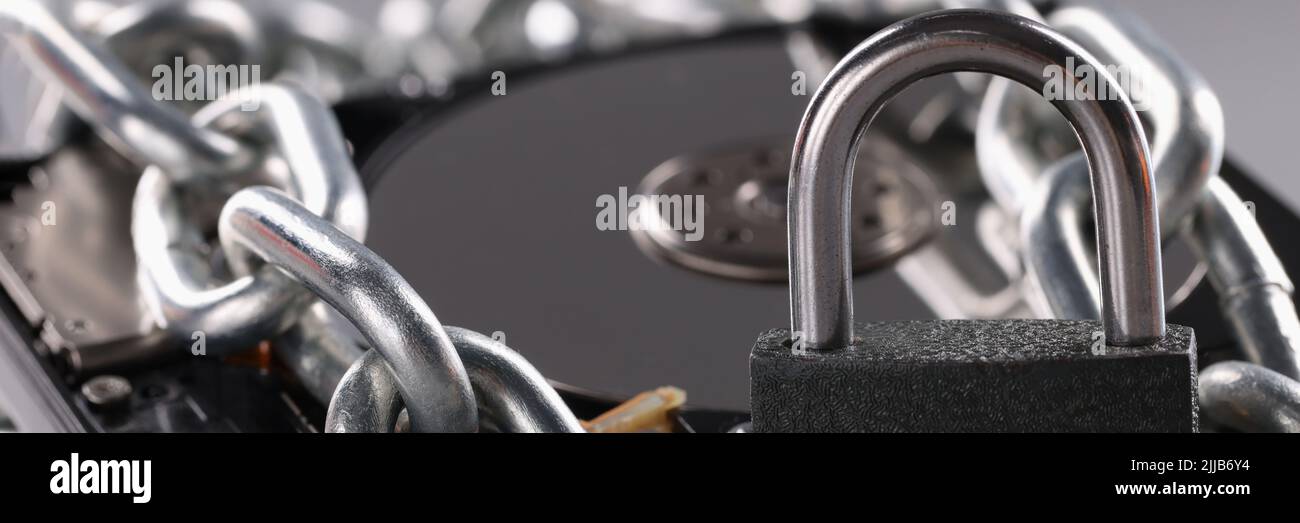 Hard drive is wrapped in chain and secured with padlock Stock Photo - Alamy