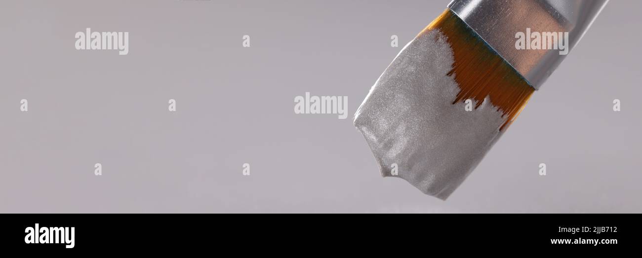Glossy metallic gray paintbrush on light background Stock Photo - Alamy