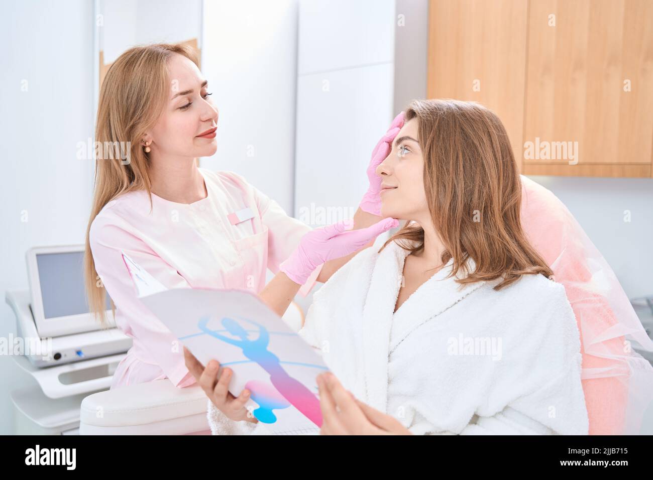 Doctor conducts a professional medical examination of a female face ...