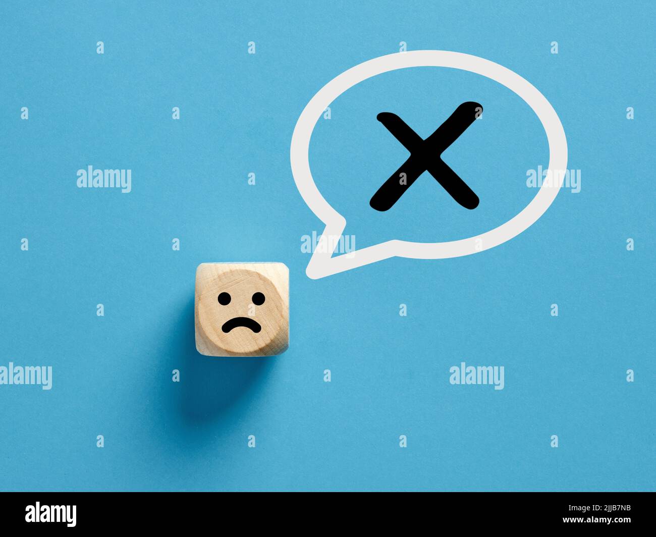 Unhappy Face Icon On A Wooden Cube With Cross X Or No Sign In A Speech Bubble No Or Rejection